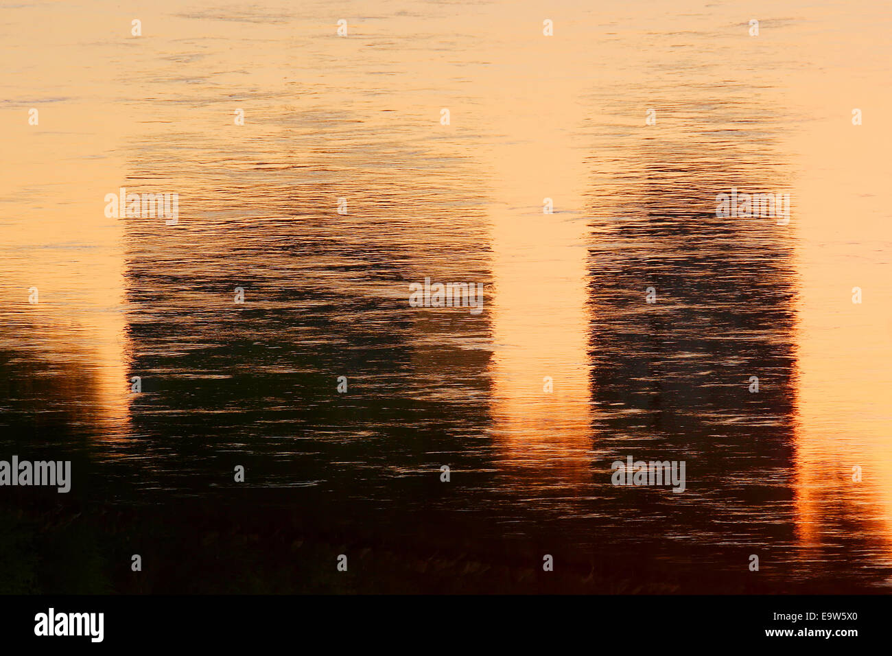 Sunlight and skyscraper reflection on the water surface of river Stock ...