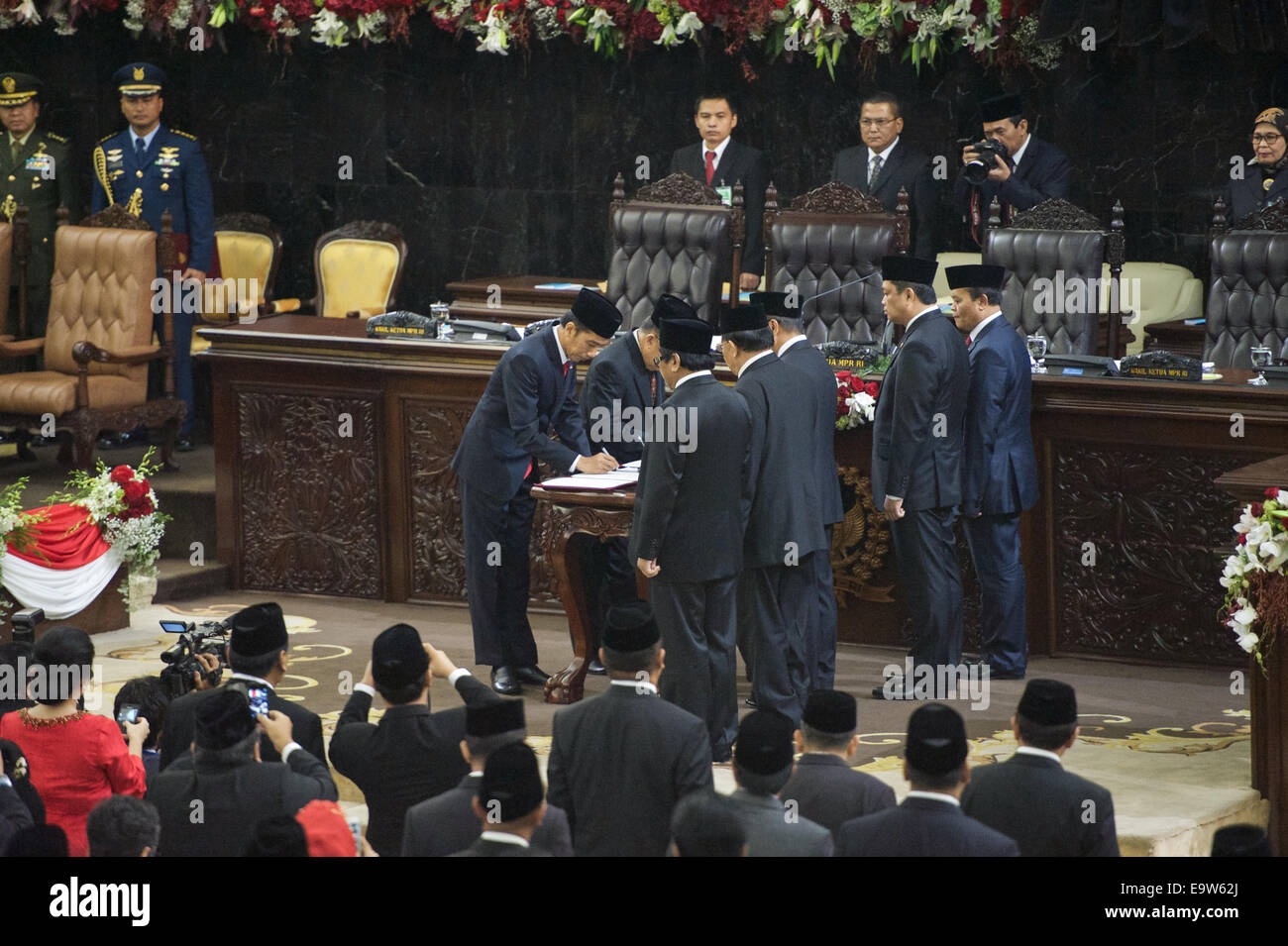 President Joko Widodo signs a certificate of authentication during his ...