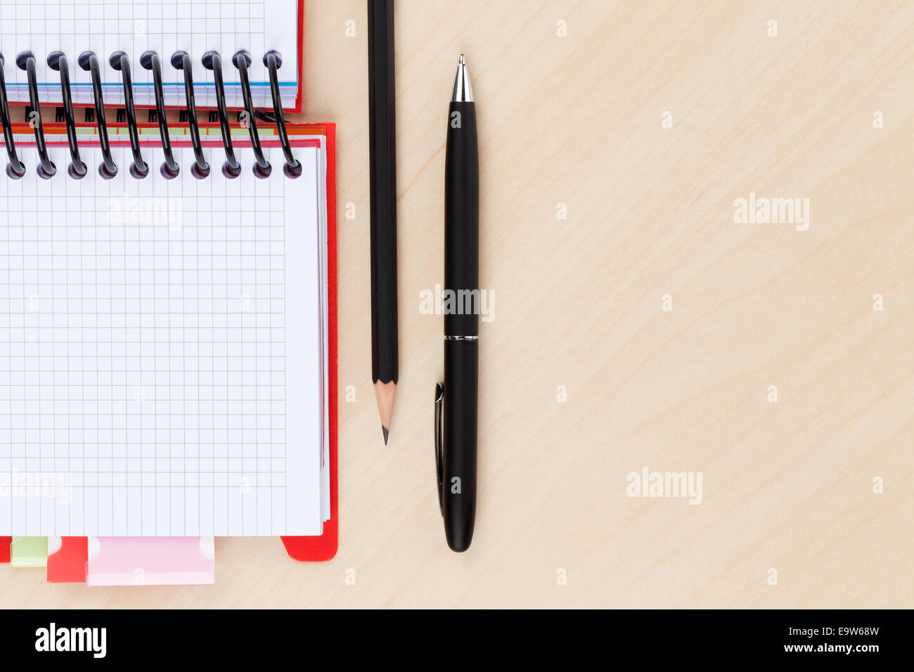 Office table with blank notepad, pen and pencil. View from above with ...