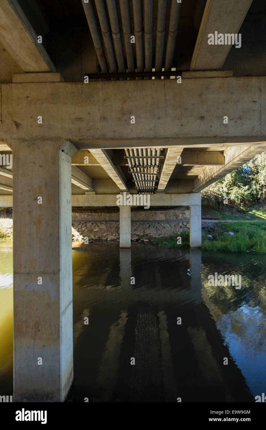The underneath of a concrete bridge/roadway over a creek Stock Photo ...