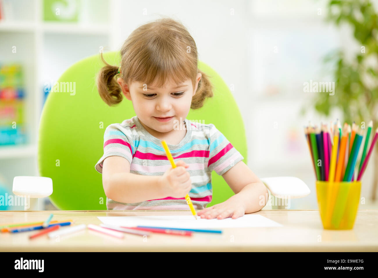 cute child girl drawing with colourful pencils Stock Photo - Alamy