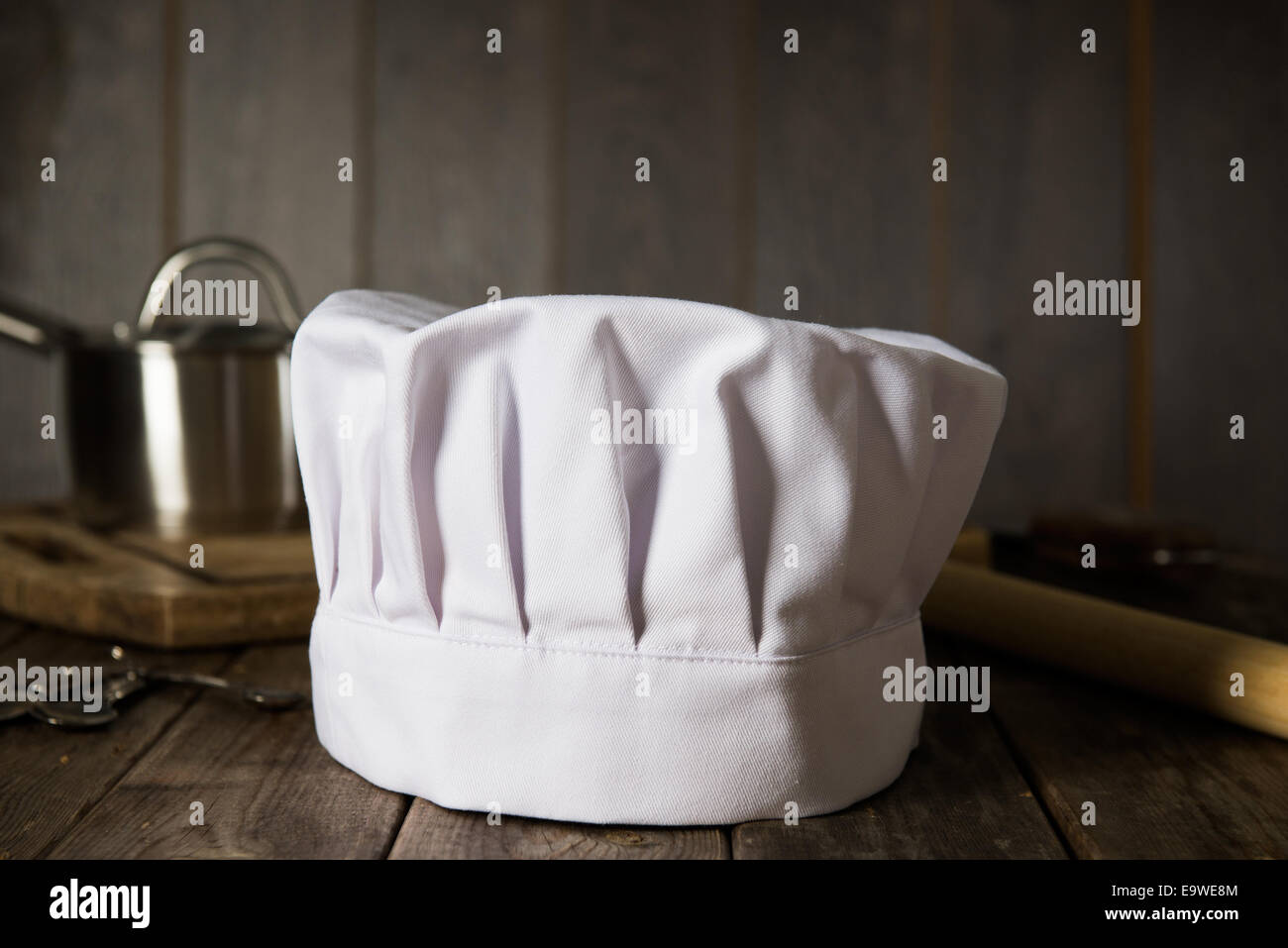 chef hat with kitchen settings and rustic look Stock Photo - Alamy