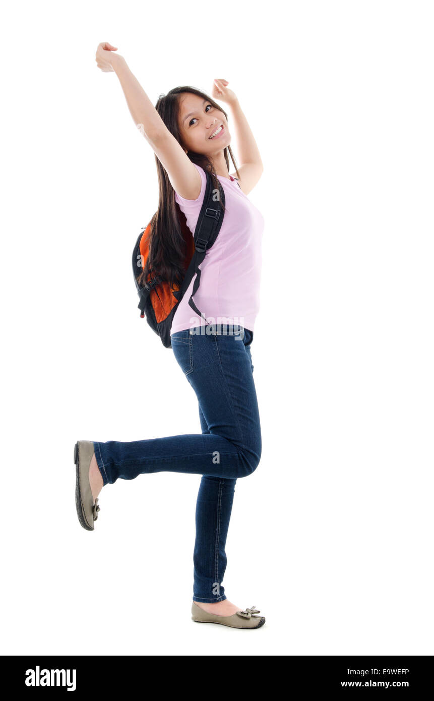 Full length pan Asian teen student cheering with arms raised, isolated ...