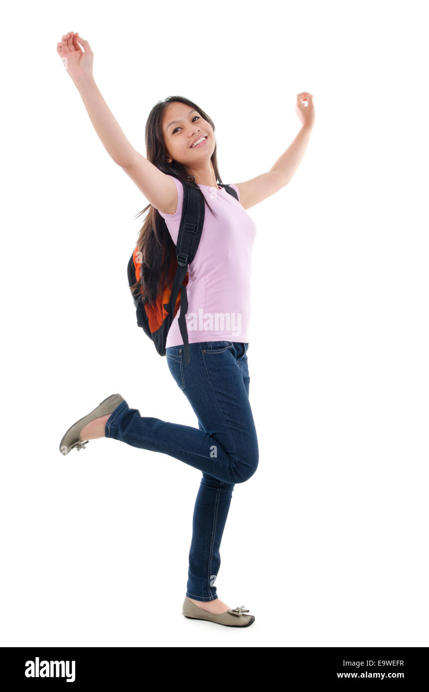 Full length pan Asian teen student cheering with hands up, isolated on ...