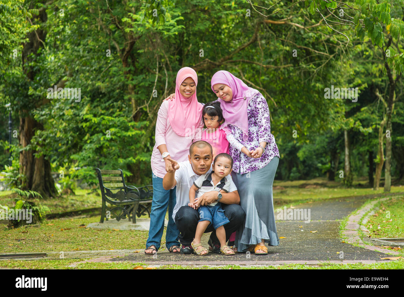 Happy Southeast Asian family outdoor lifestyle at nature green park ...
