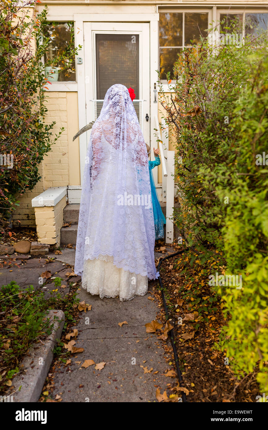 Trick or treating in costumes on Halloween night Stock Photo - Alamy