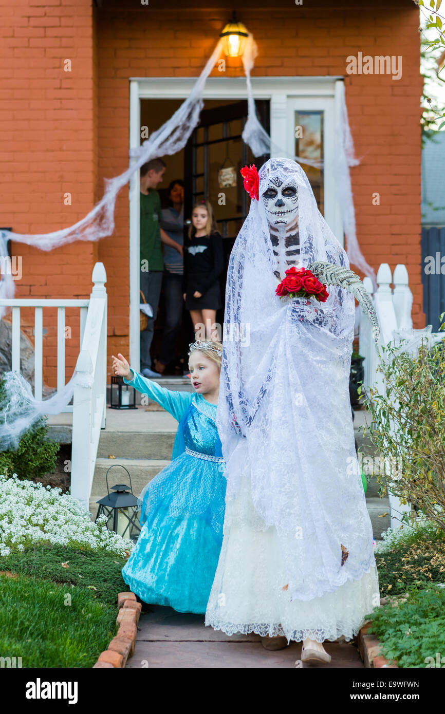 Trick or treating in costumes on Halloween night Stock Photo - Alamy