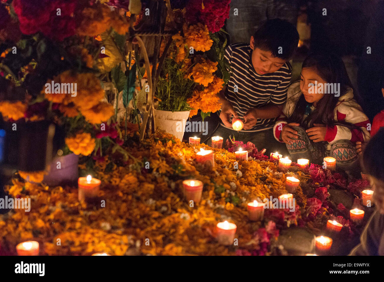Oaxaca, Oaxaca, Mexico. 2nd Nov, 2014. Children light candles at the ...