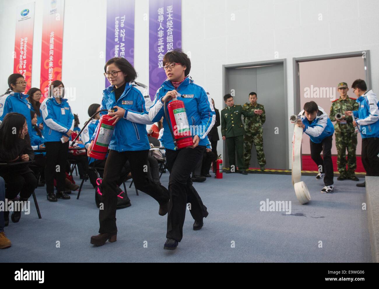 Beijing, China. 3rd Nov, 2014. Volunteers take part in a fire ...