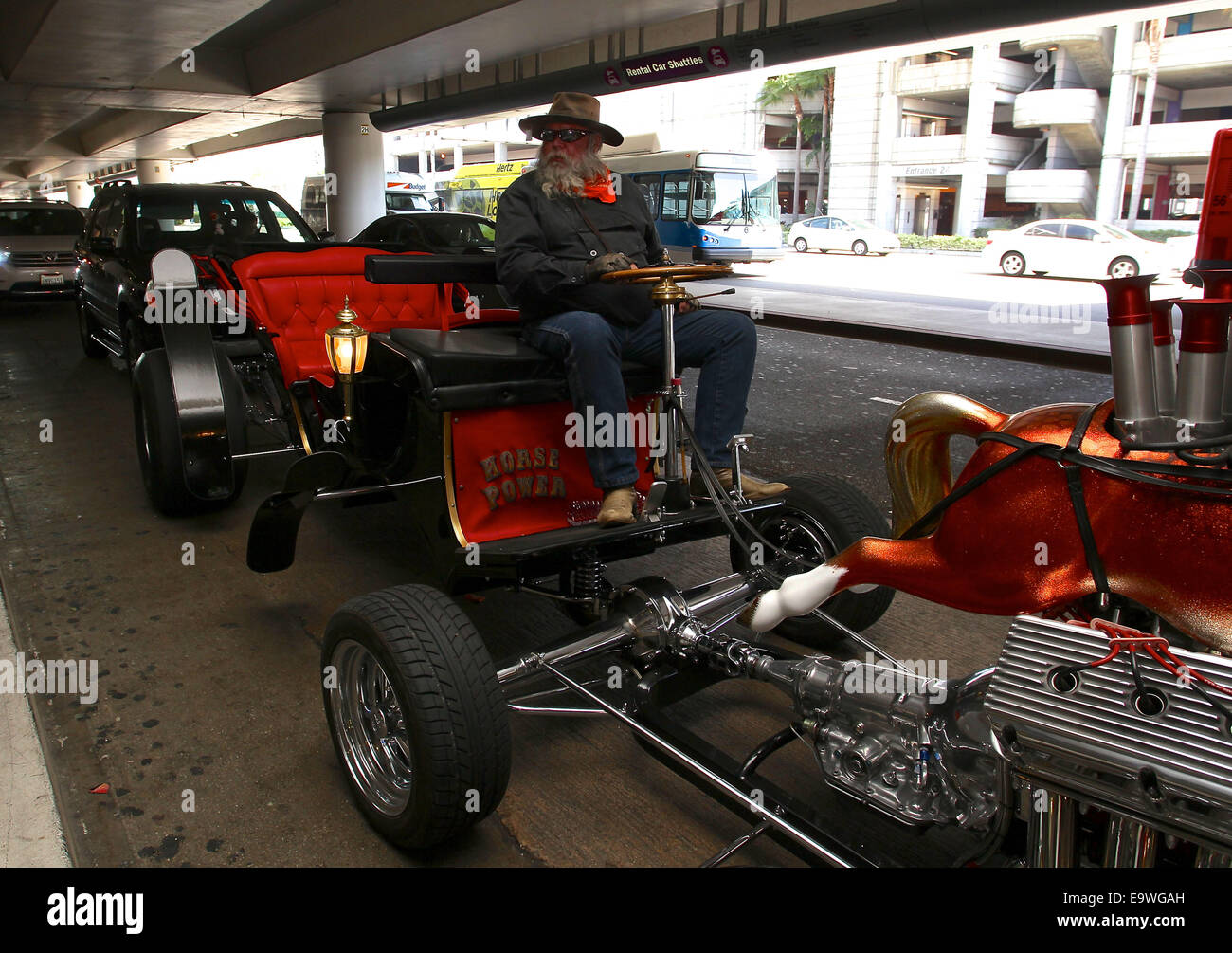 A fully licensed horseless carriage sits idle as the driver waits to ...