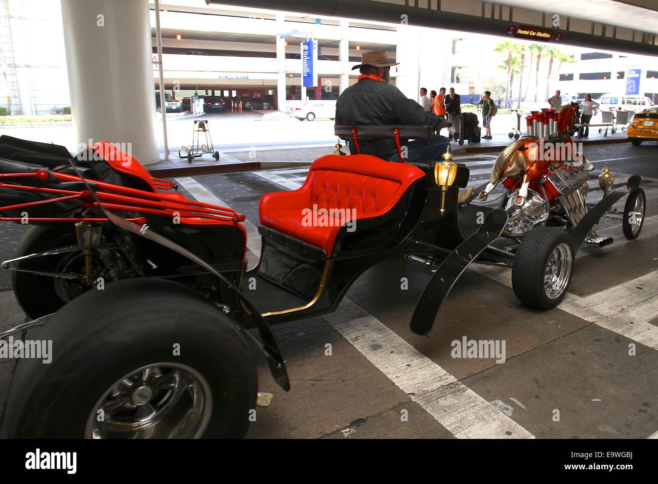 A fully licensed horseless carriage sits idle as the driver waits to ...