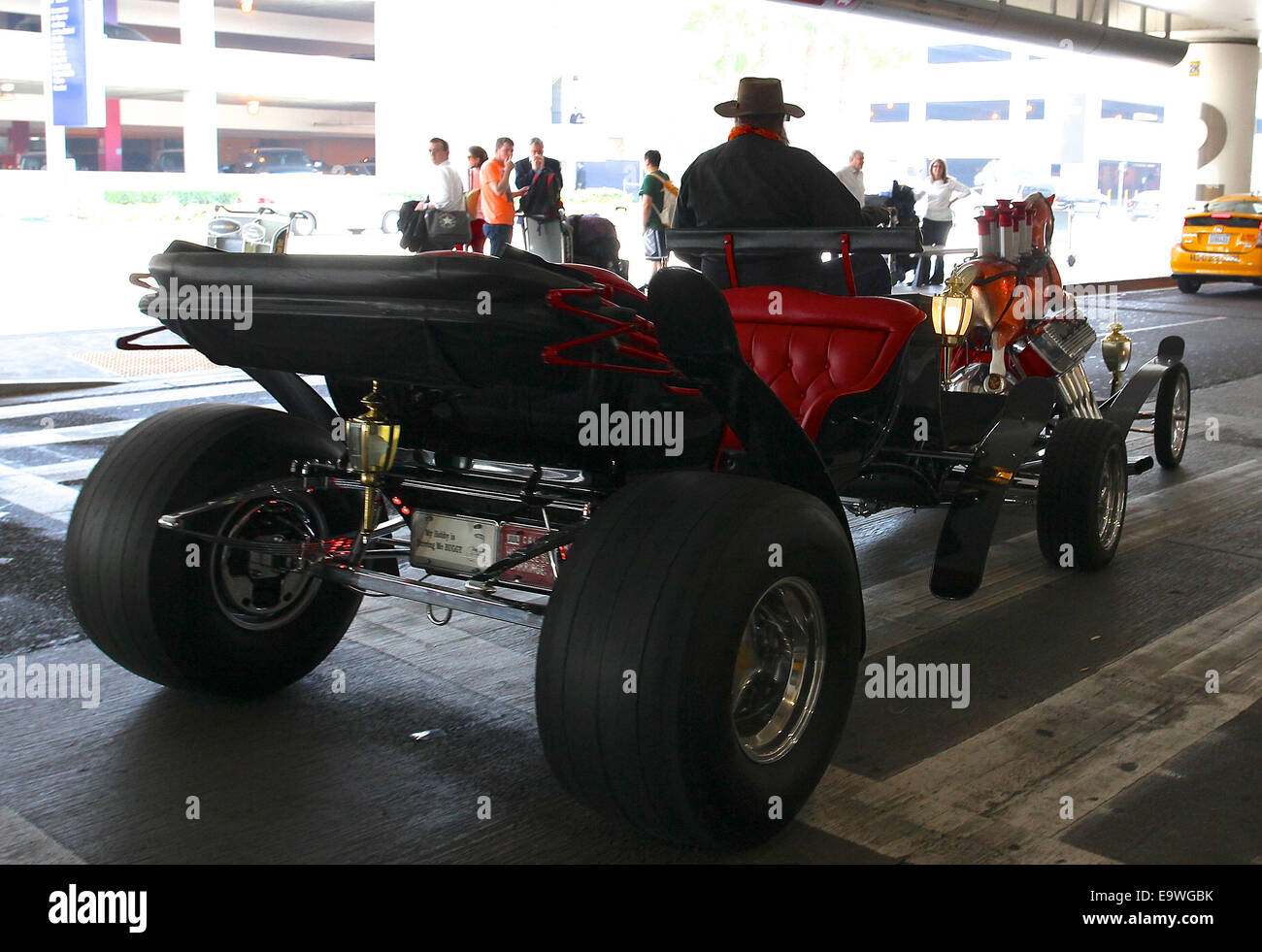 A fully licensed horseless carriage sits idle as the driver waits to ...