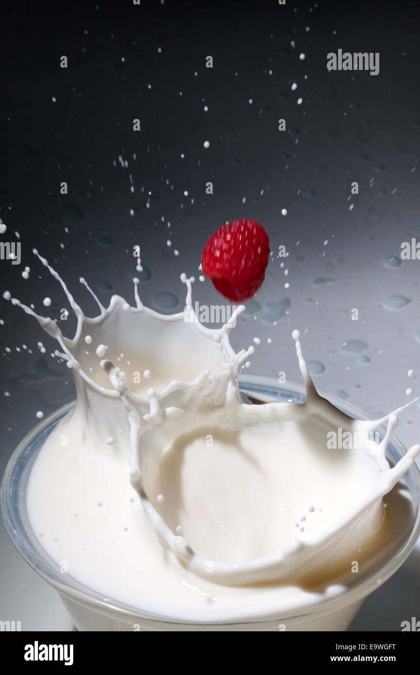 Raspberries fall into milk Stock Photo - Alamy