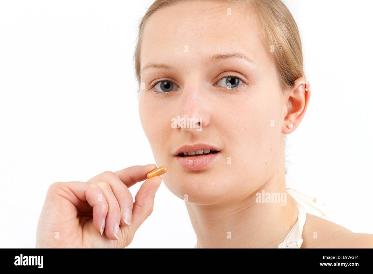 Young woman ingests a capsule Stock Photo - Alamy