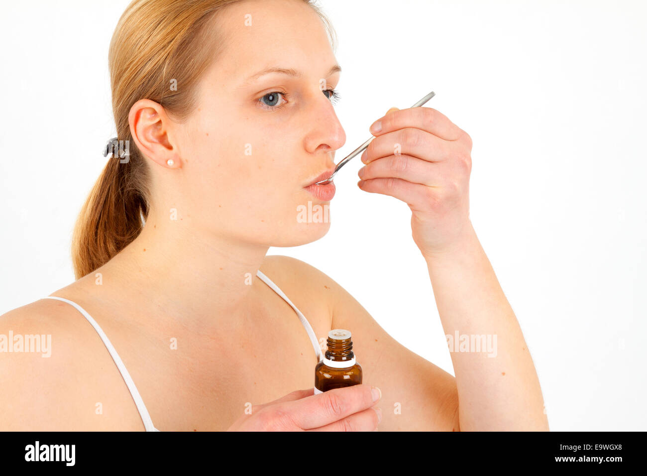 Woman takes medical drops Stock Photo - Alamy