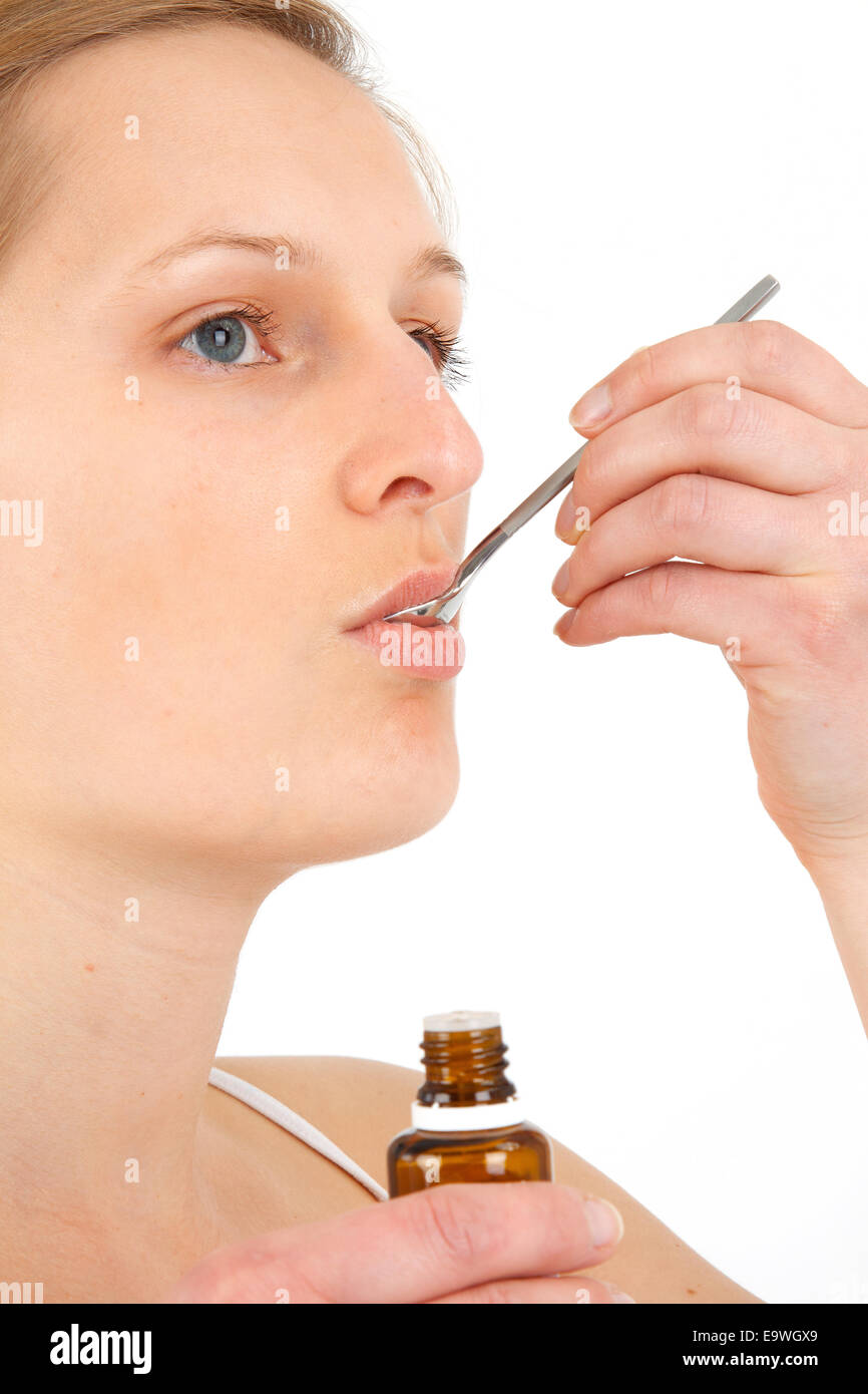 Woman takes medical drops Stock Photo - Alamy