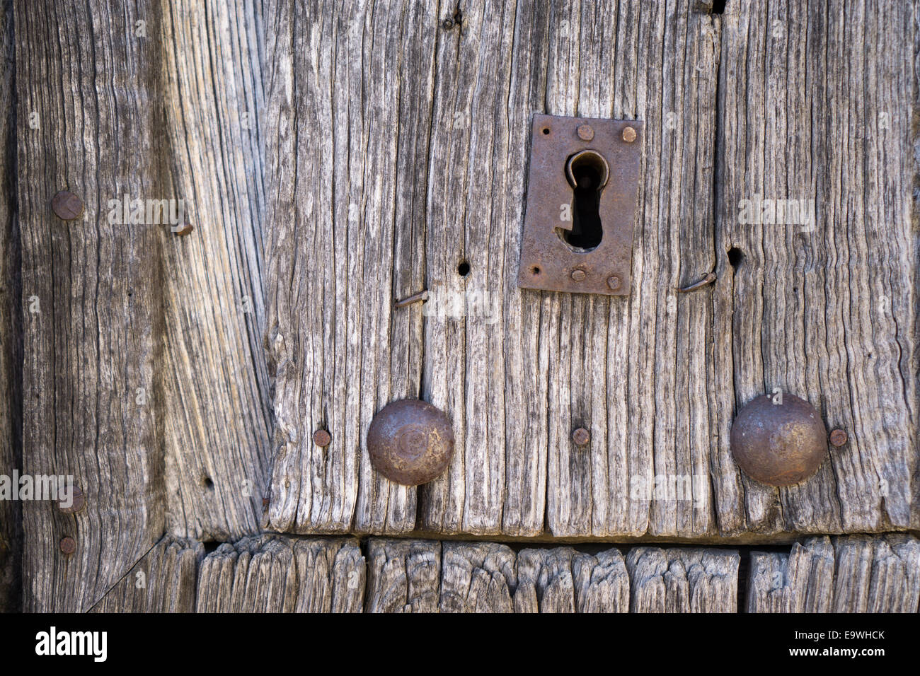 Front view of old lock and wooden door with iron nails Stock Photo - Alamy