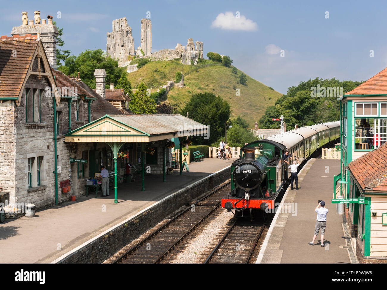 High angle view of steam engine train arriving at Corfe Castle station ...