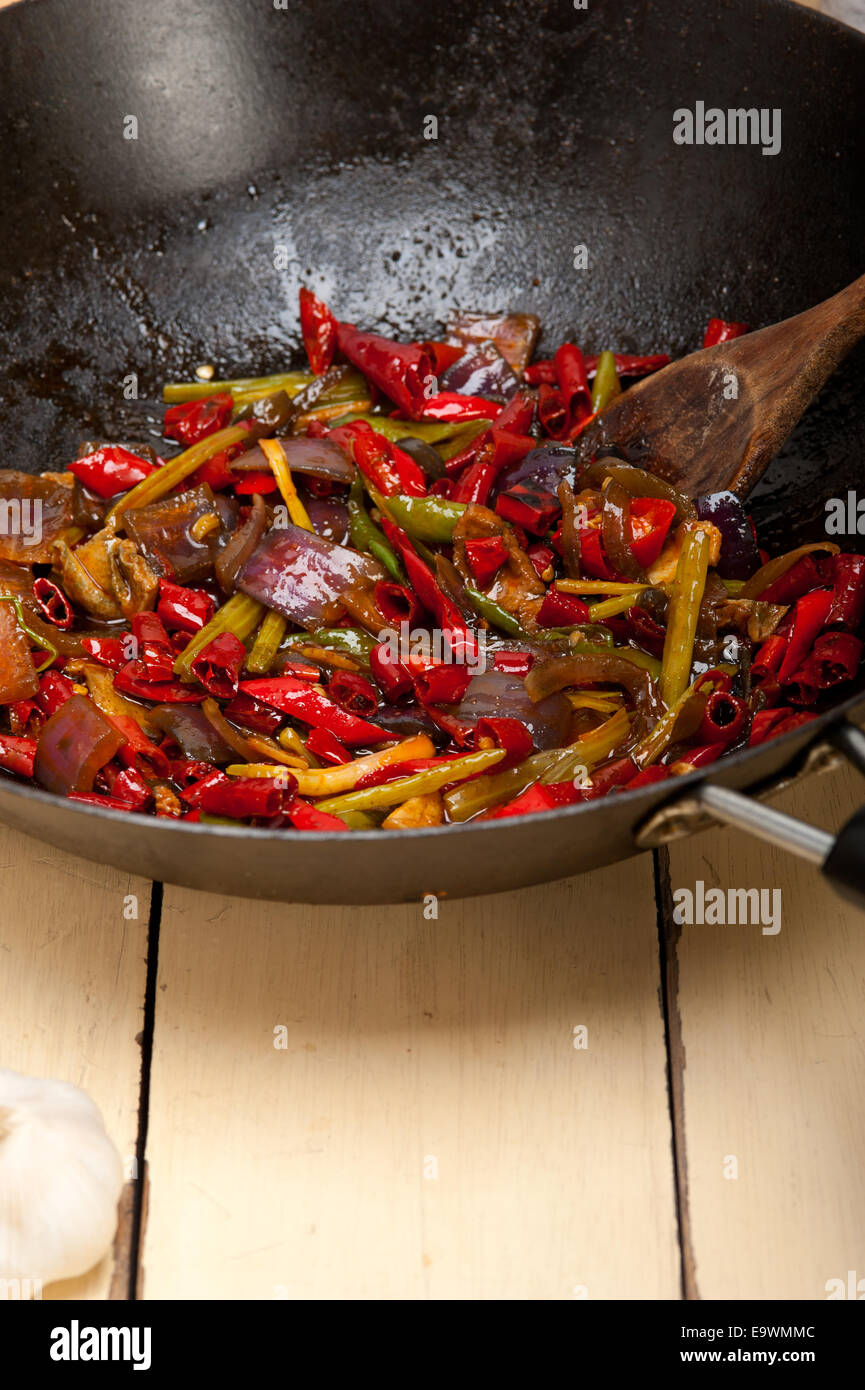 fried chili pepper and vegetable on a iron wok pan Stock Photo - Alamy