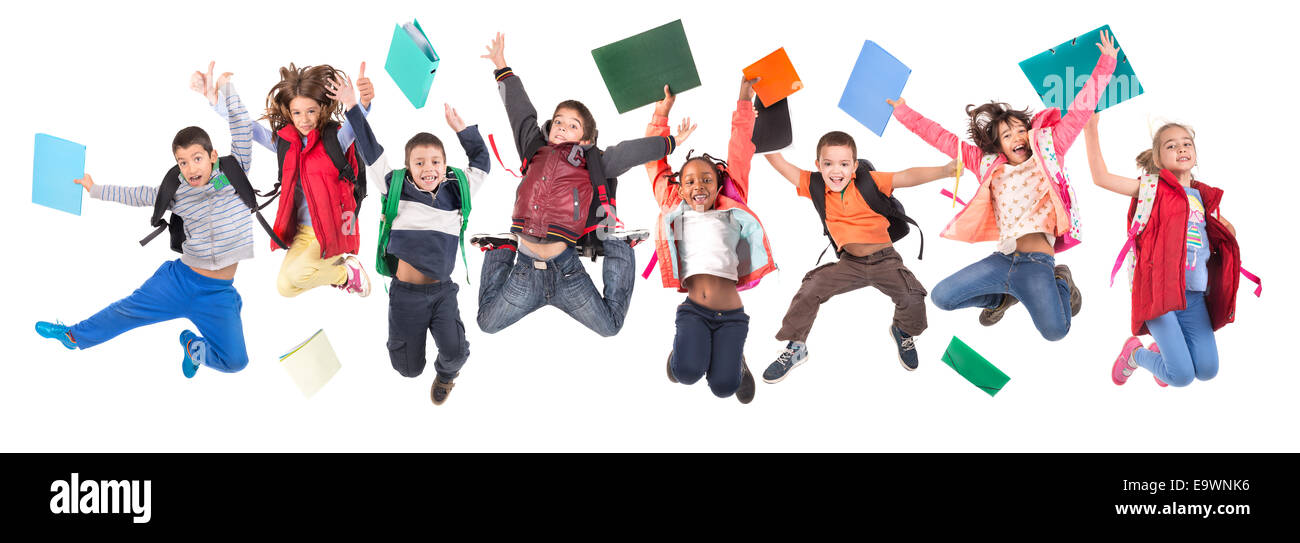 Group of school children jumping isolated in white Stock Photo - Alamy