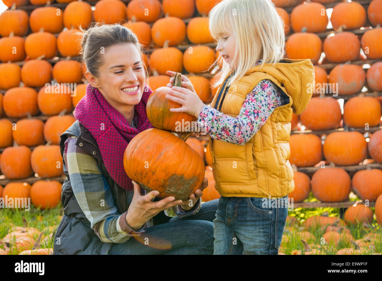 Mother and child choosing pumpkins Stock Photo - Alamy