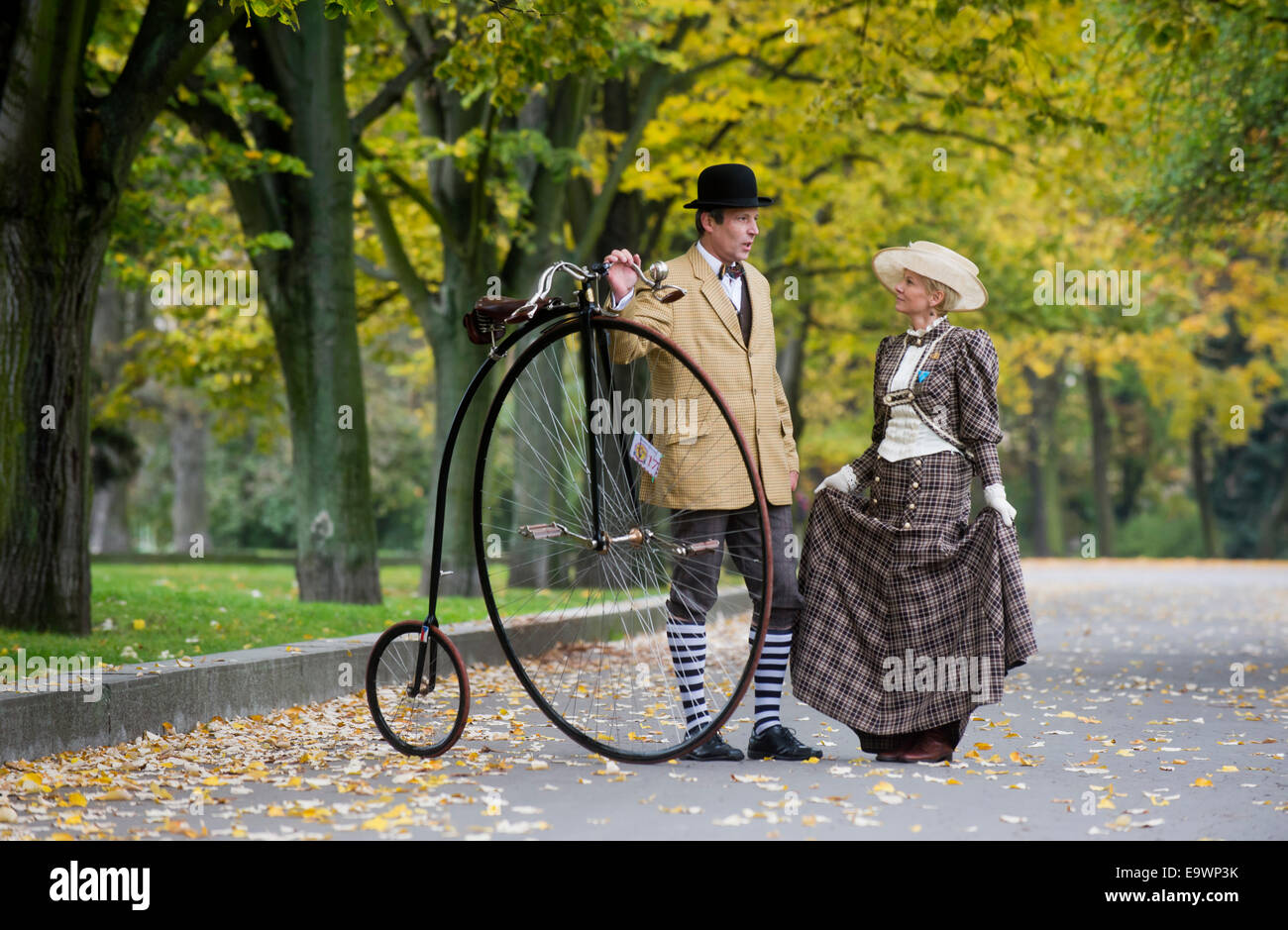 Velocipedists, men and women on historic bikes and in period costumes ...