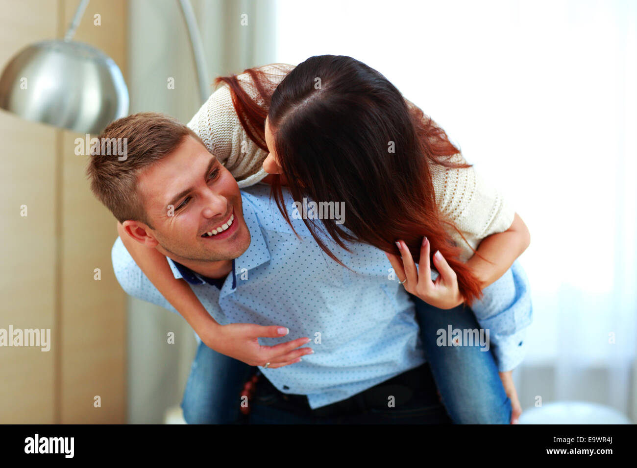 Happy couple having fun at home and looking at each other Stock Photo ...