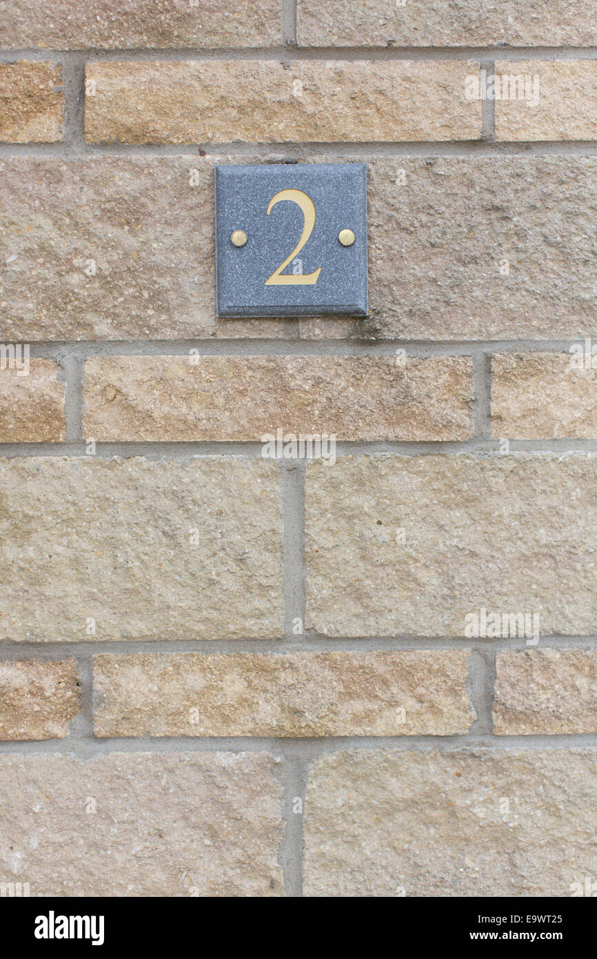 Number two sign for a house, on a wall Stock Photo - Alamy