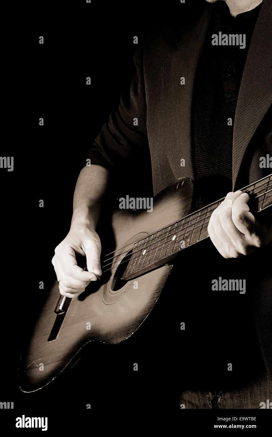 sepia man and guitar at black background Stock Photo - Alamy