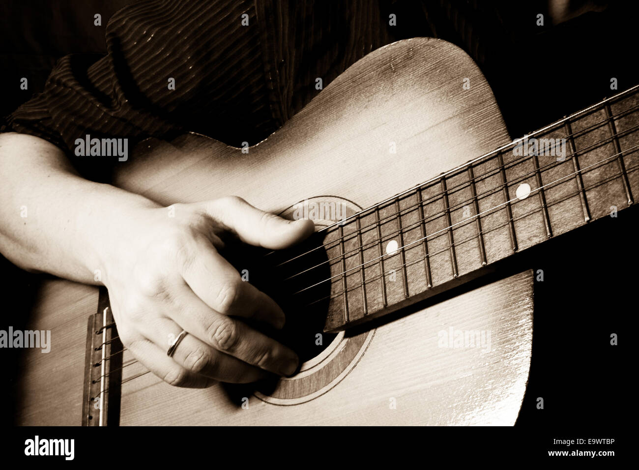 hand playing guitar at black background Stock Photo - Alamy