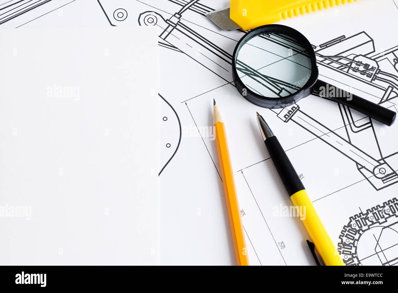 Magnifier and office accessory at draft Stock Photo - Alamy