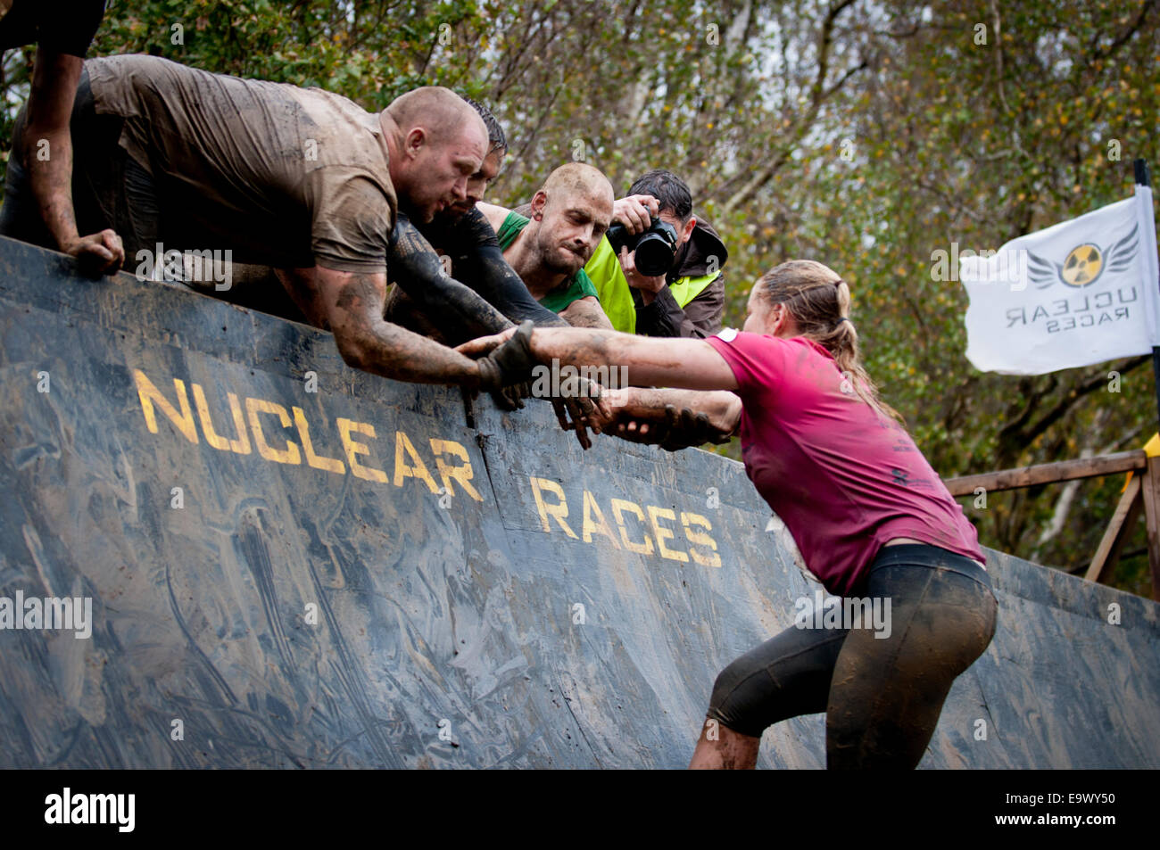 Participants battle against obstacles and mud in the 2014 Nuclear Races ...