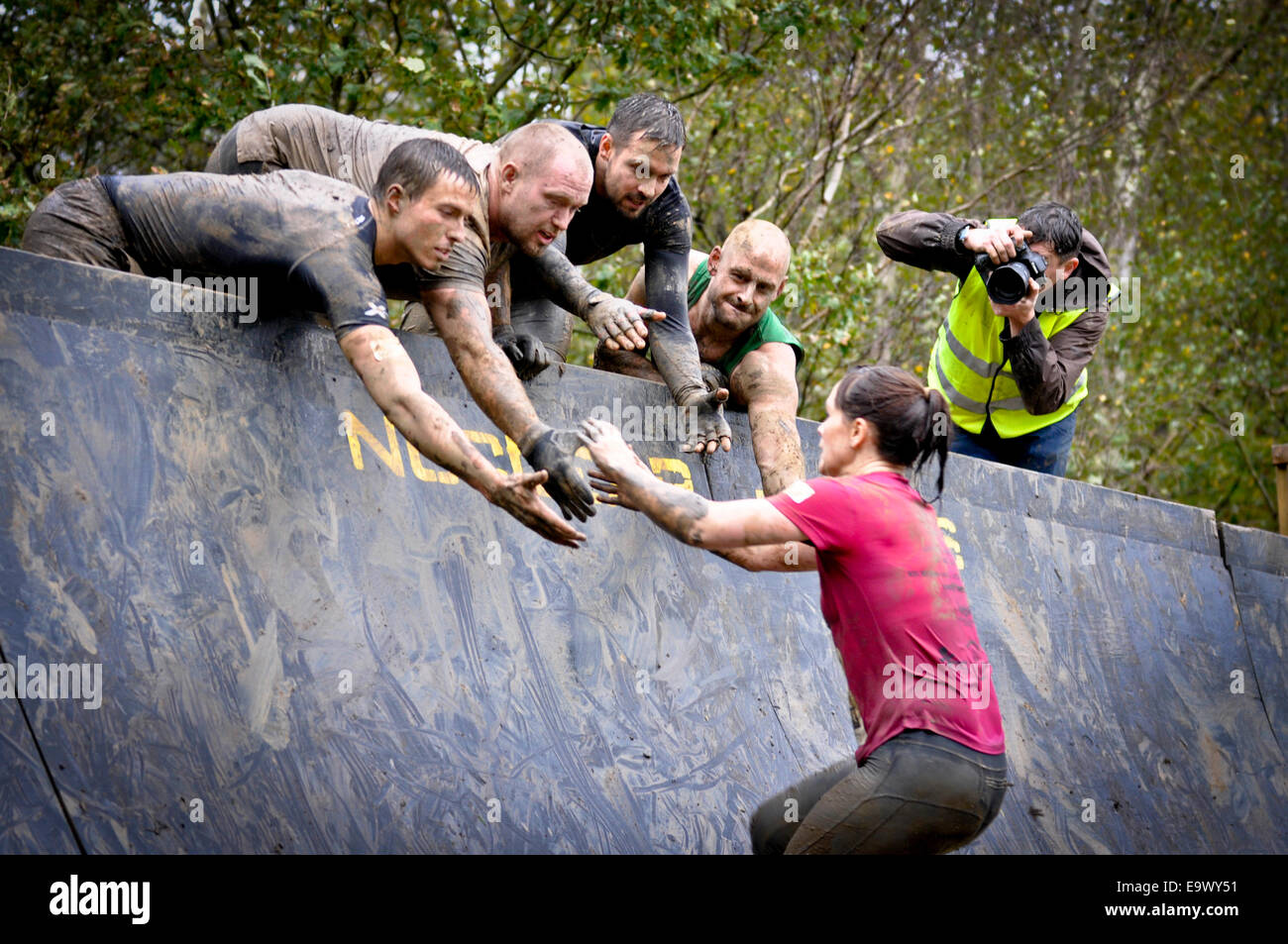 Participants battle against obstacles and mud in the 2014 Nuclear Races ...