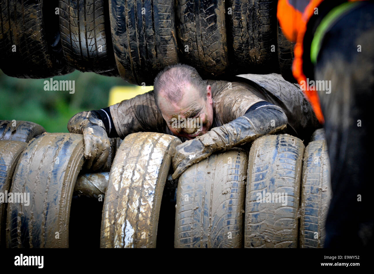 Participants battle against obstacles and mud in the 2014 Nuclear Races ...