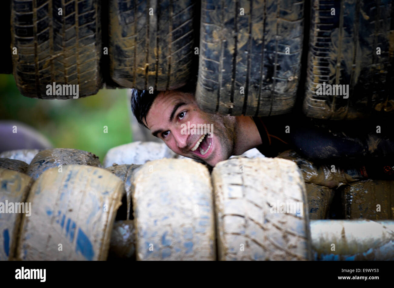 Participants battle against obstacles and mud in the 2014 Nuclear Races ...