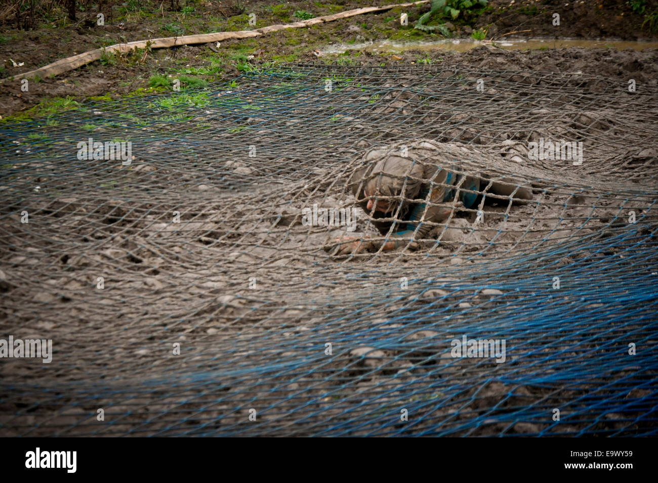 Participants battle against obstacles and mud in the 2014 Nuclear Races ...