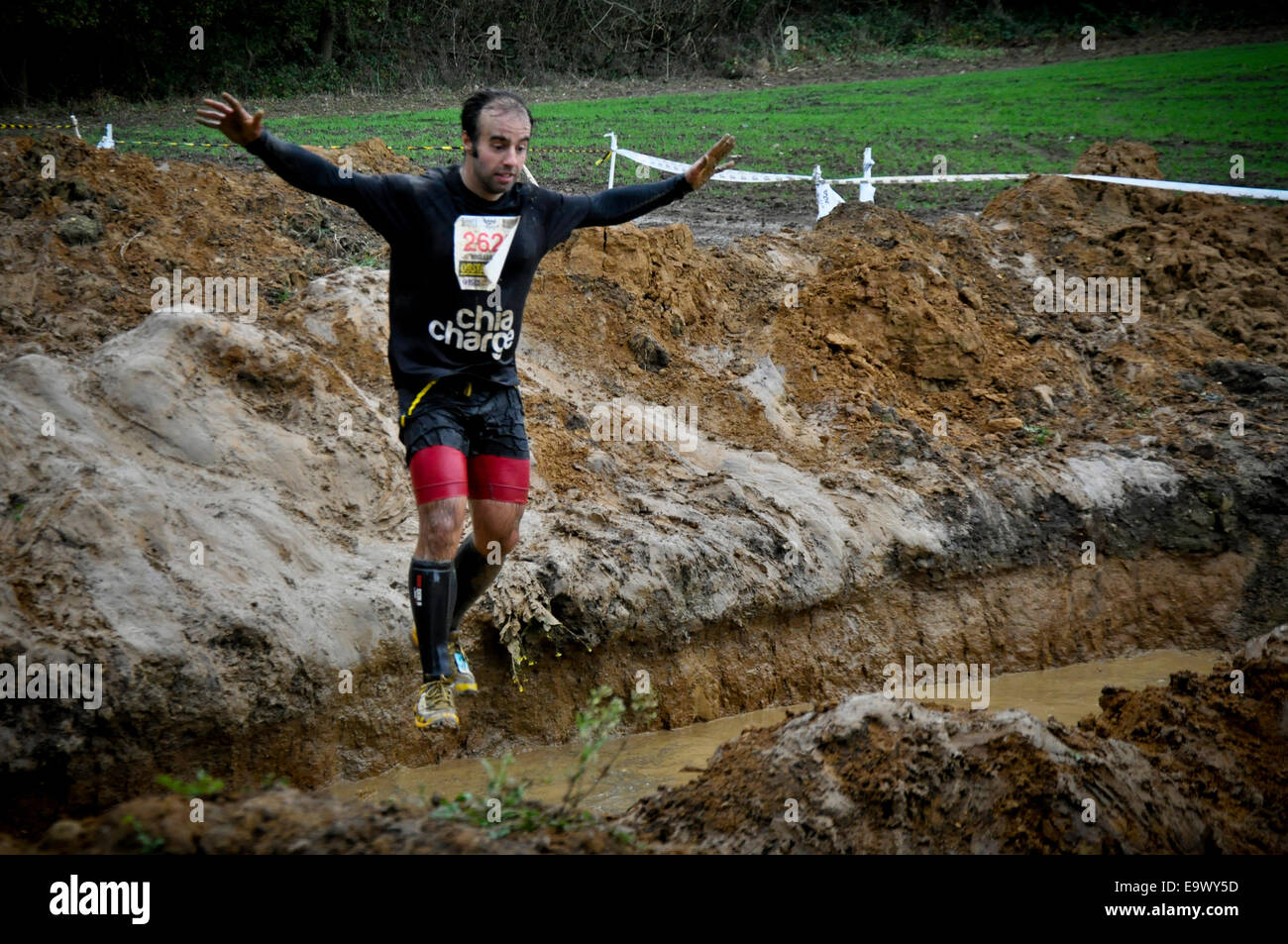 Participants battle against obstacles and mud in the 2014 Nuclear Races ...