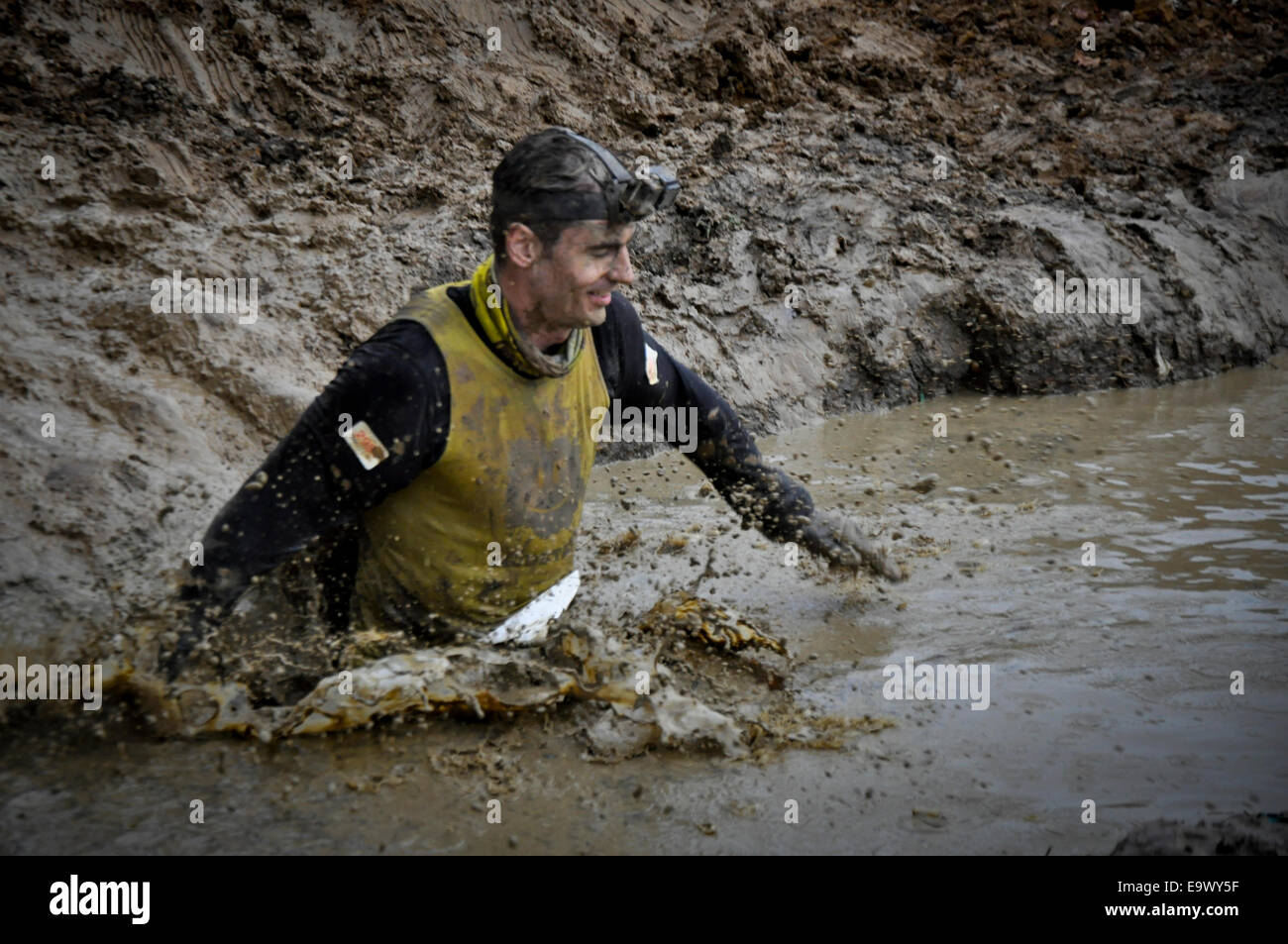 Participants battle against obstacles and mud in the 2014 Nuclear Races ...