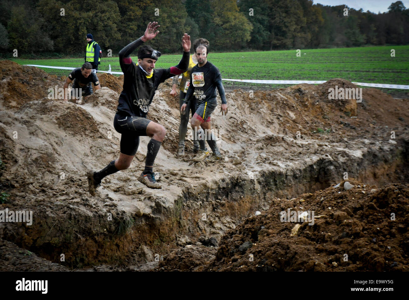 Participants battle against obstacles and mud in the 2014 Nuclear Races ...
