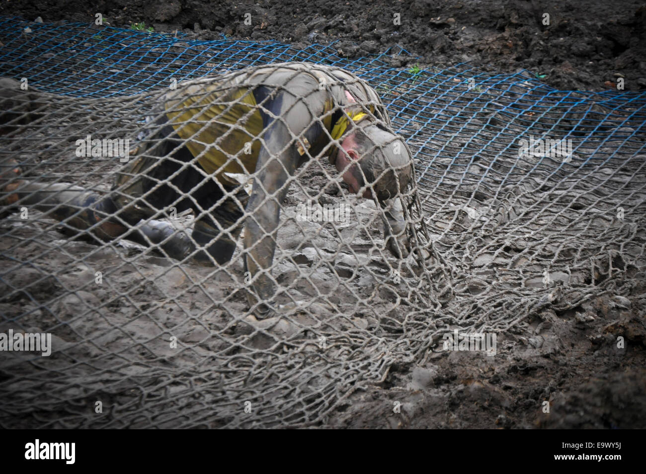 Participants battle against obstacles and mud in the 2014 Nuclear Races ...