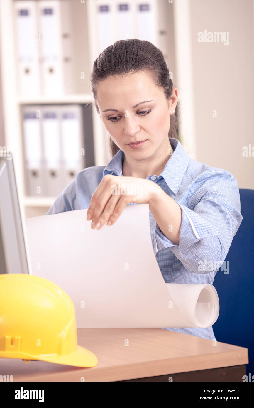 A young female architect working in the office Stock Photo - Alamy