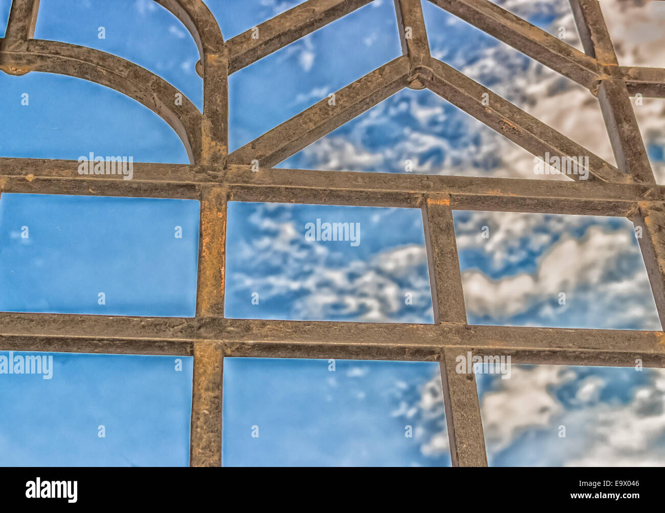 Black iron grating on cloudy summer sky: straight line creates square ...