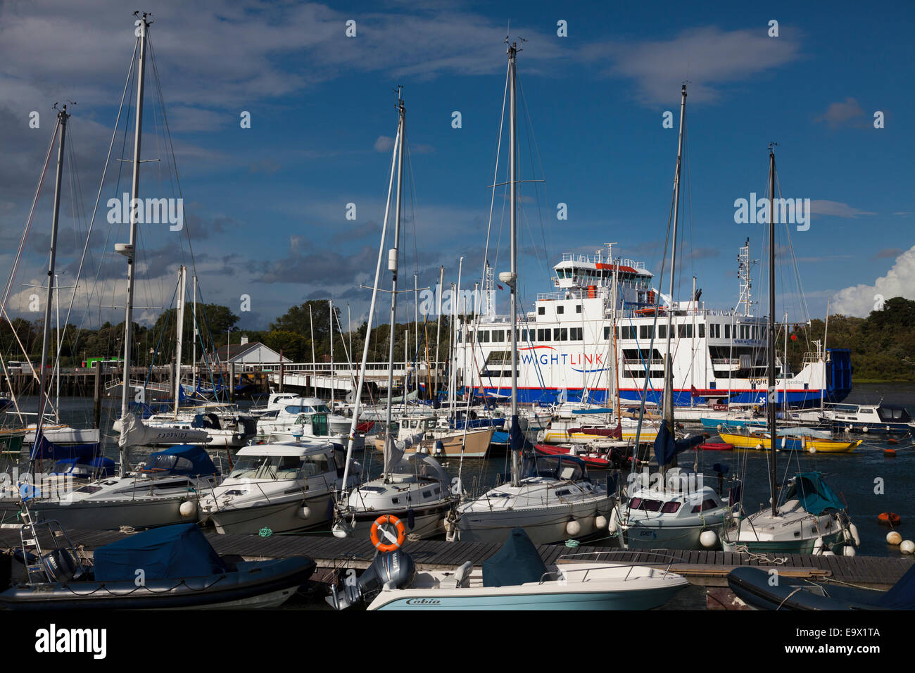 Wightlink car ferry enters Lymington harbour past moored yachts Stock ...
