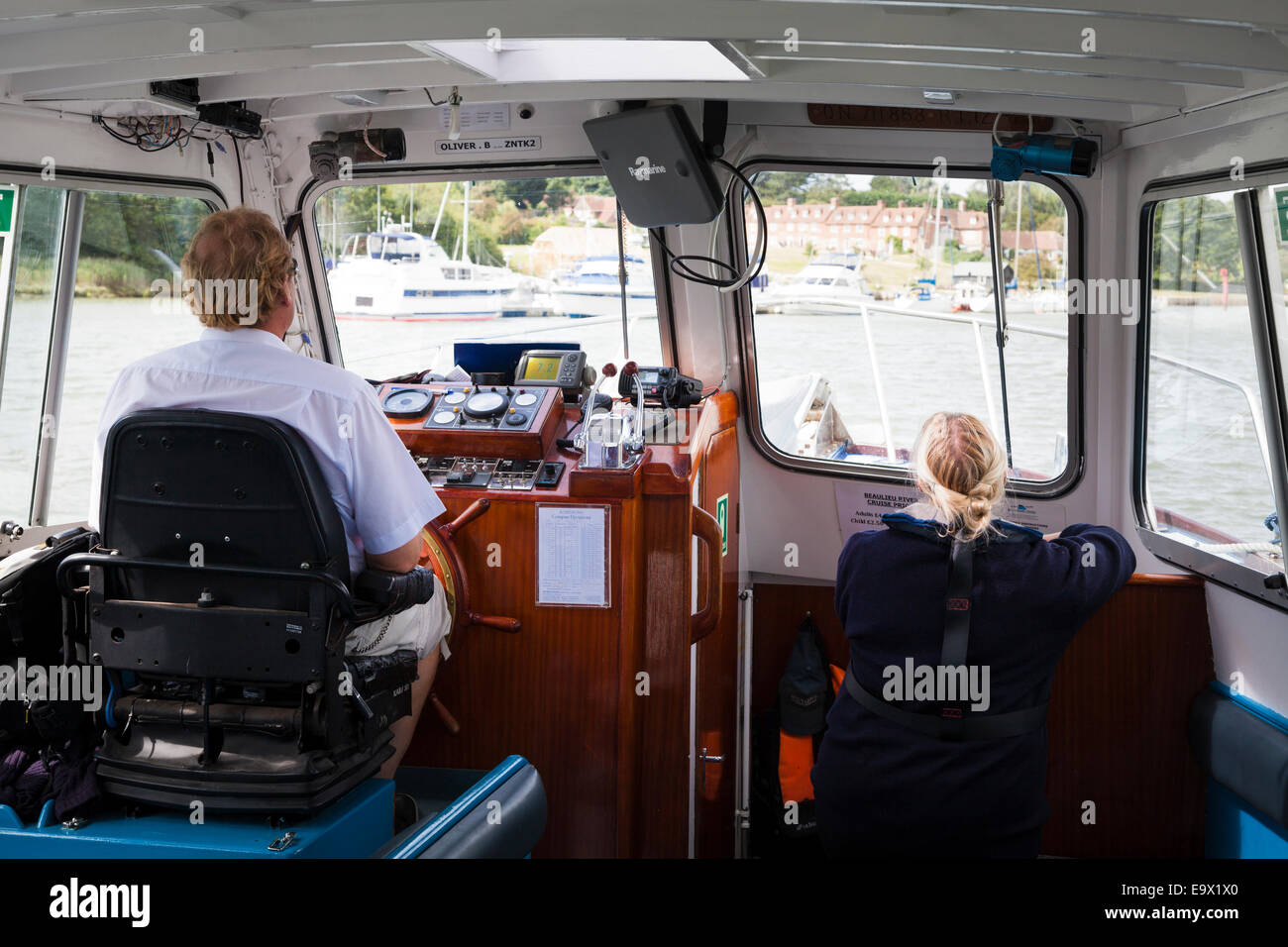 Skipper steering motor boat river cruiser Stock Photo - Alamy