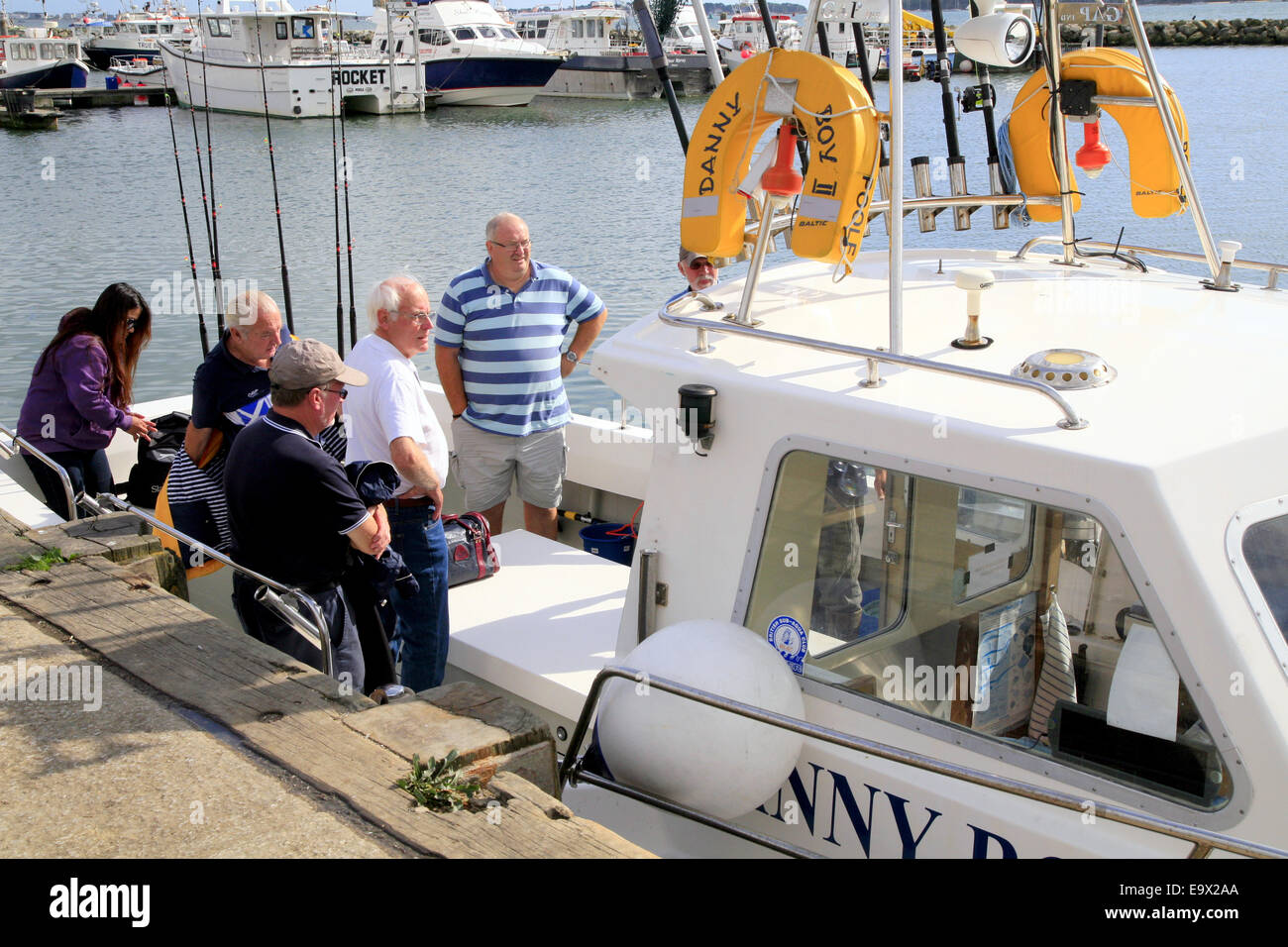 A group of fishermen listning to instructions before setting out on a ...