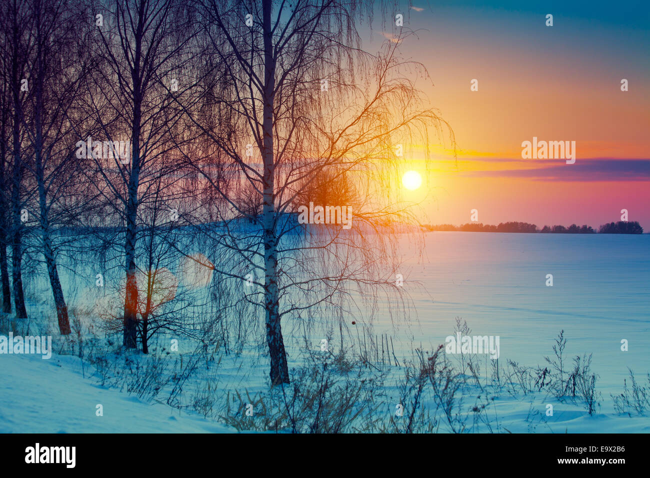 Beautiful winter sunset over snowy field Stock Photo - Alamy