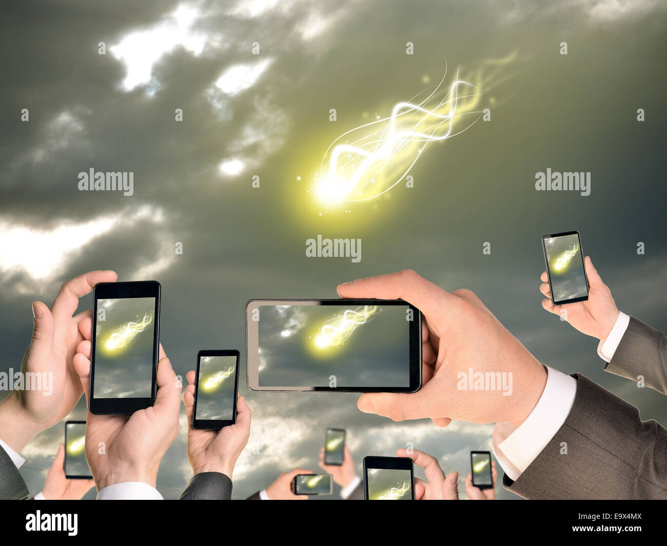 Hands holding smart phones and shoot video as falling meteorite or ...
