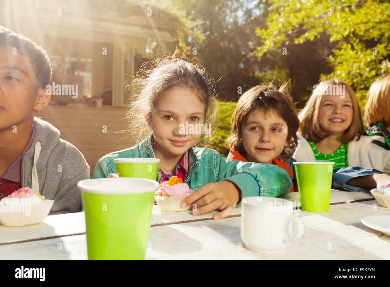 Happy friends with colorful cups and cupcakes Stock Photo - Alamy