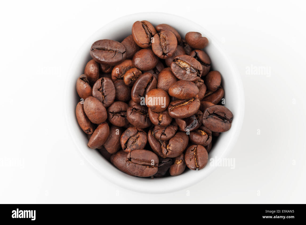 Small white espresso cup full of fresh roasted coffee beans on white ...