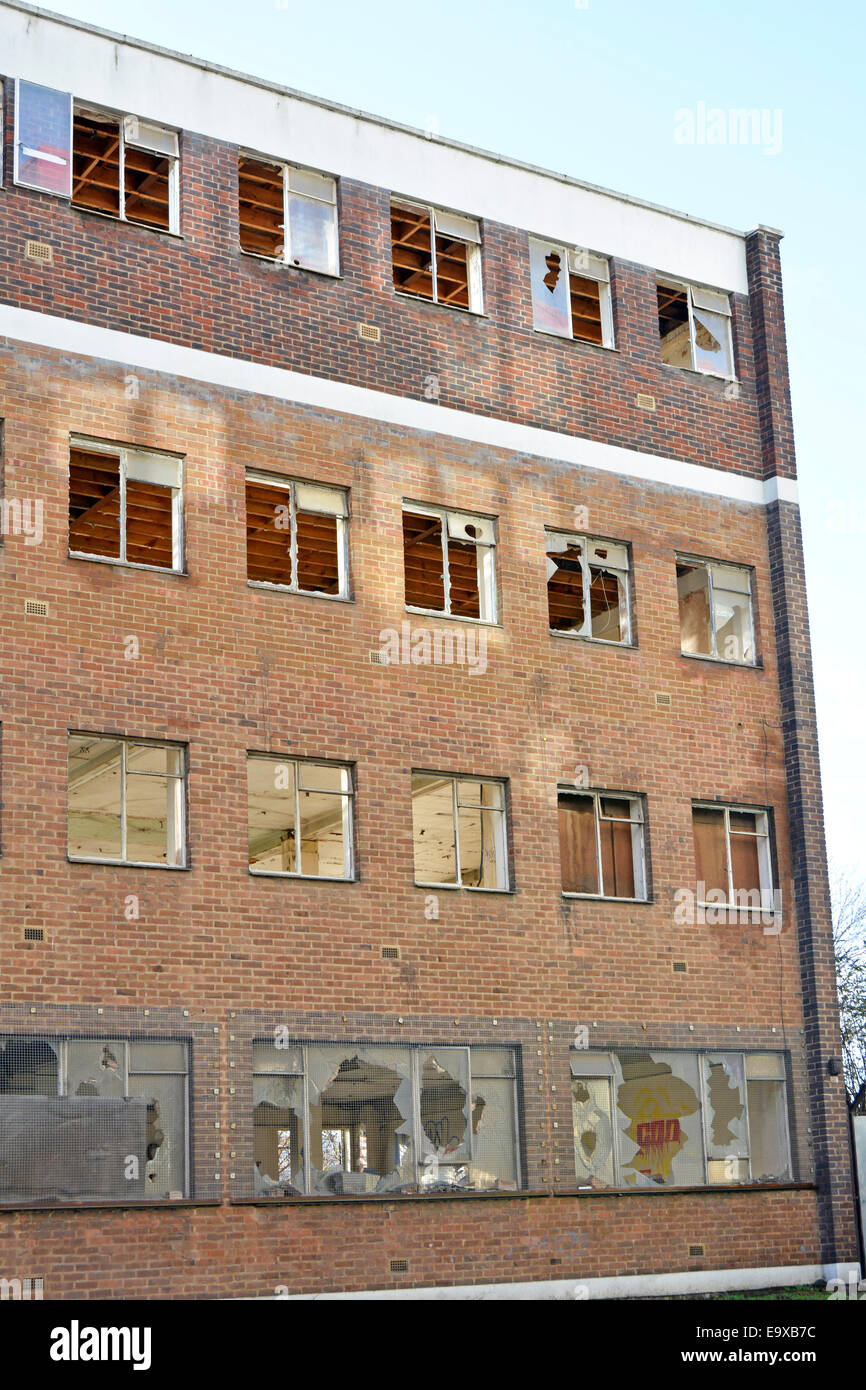 Derelict four storey brick built industrial premises badly vandalised ...